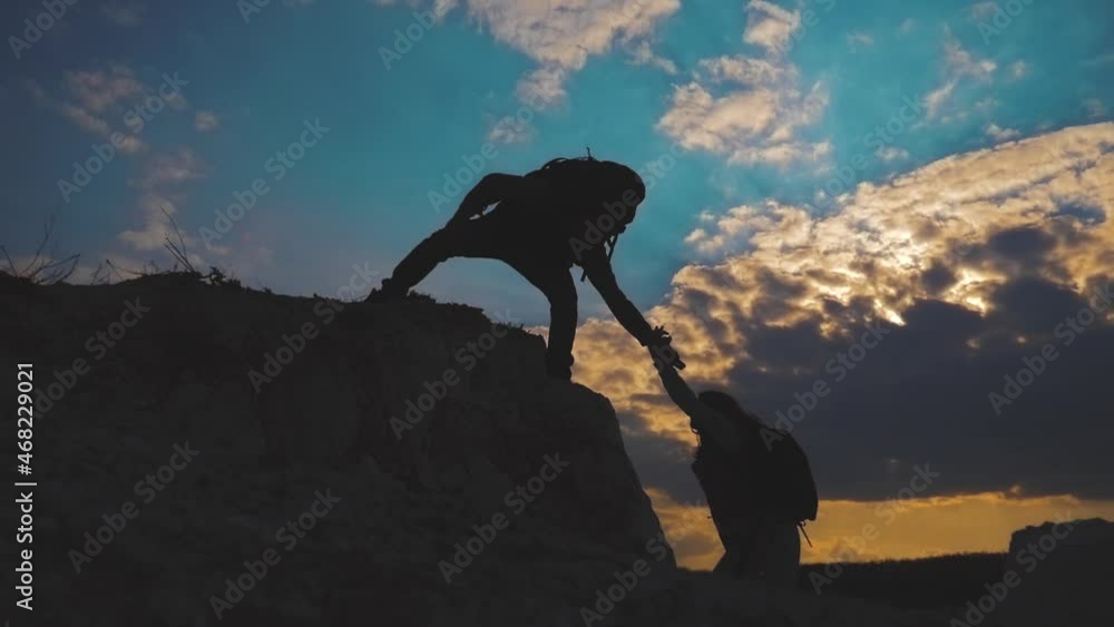teamwork help business travel silhouette at sunset sunlight slow motion ...