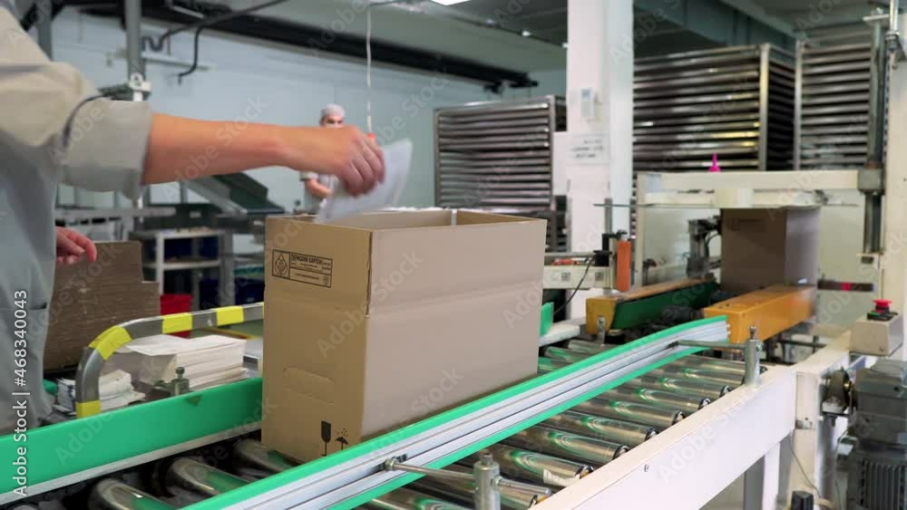 Manufacturing Facility. A Worker Wearing the uniform is Placing the ...