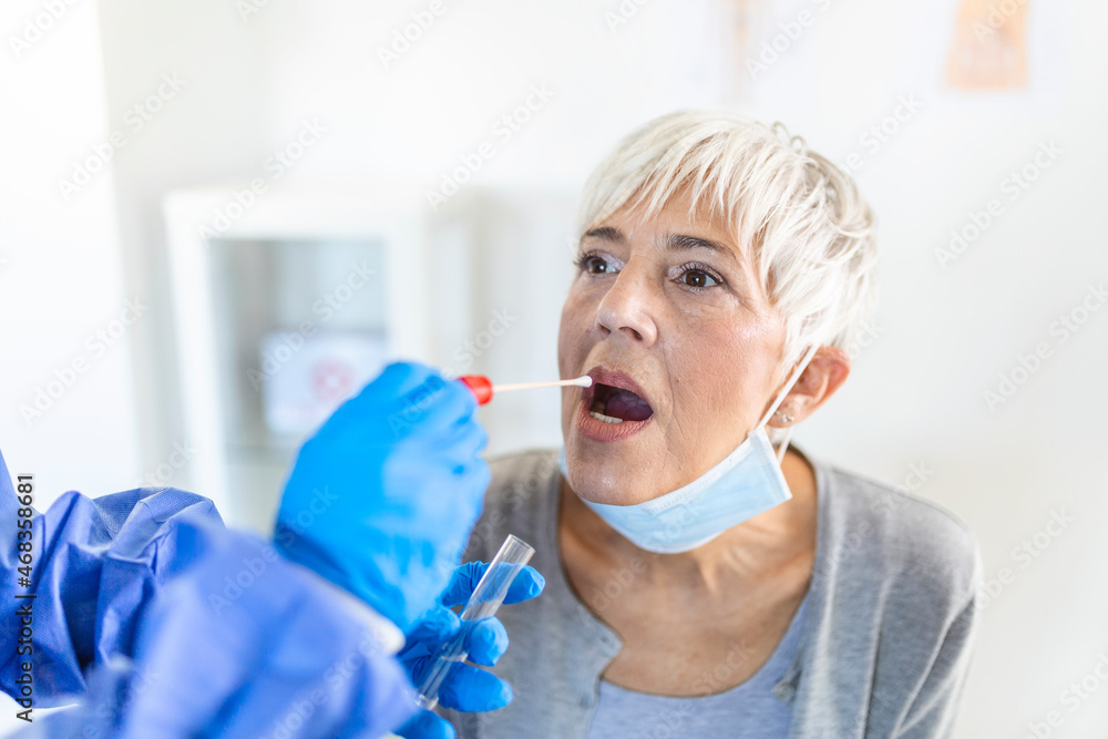 Physician wearing personal protective equipment performing a ...