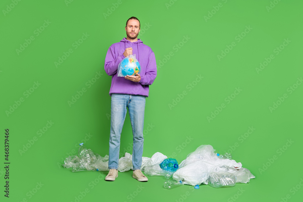 Full length photo of warn guy hold earth plastic bag litter lie floor ...
