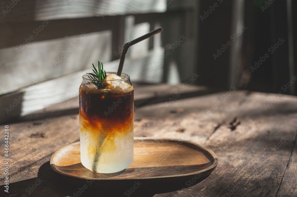 Iced coffee with lemon and mix soda on wood rustic. A glass of ...