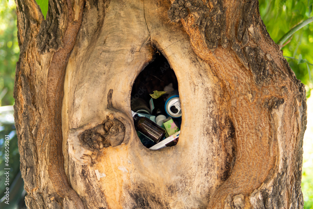 concept of environmental pollution. Garbage on a tree in the forest ...