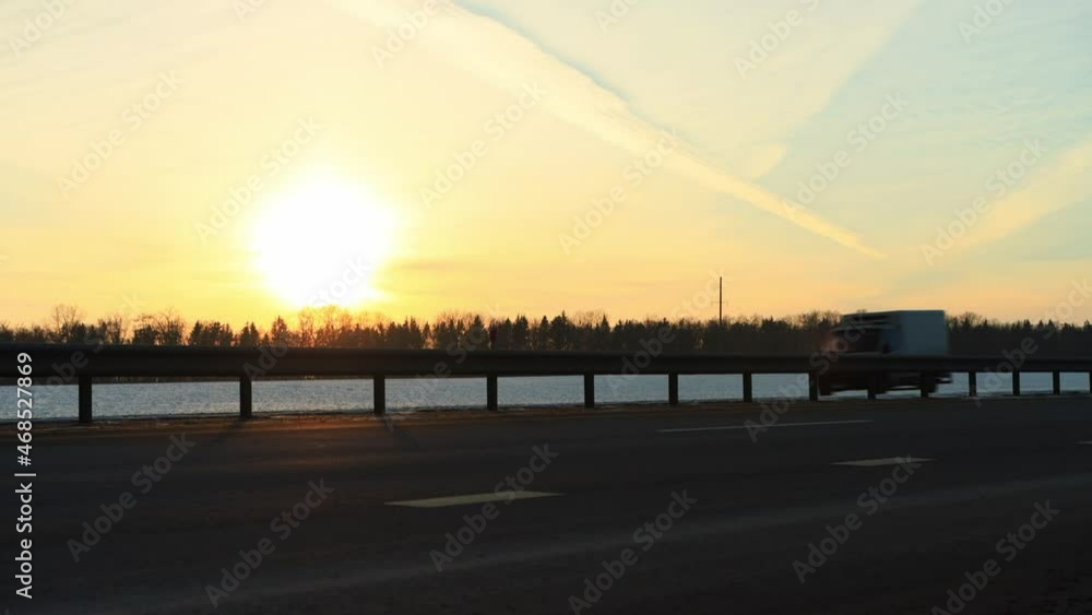 Cars and vans drive the motorway on a frosty winter evening with the ...