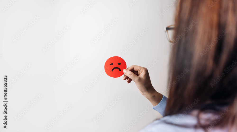 Hand holding paper cut sad face. Concept of anxiety, stress or sad ...