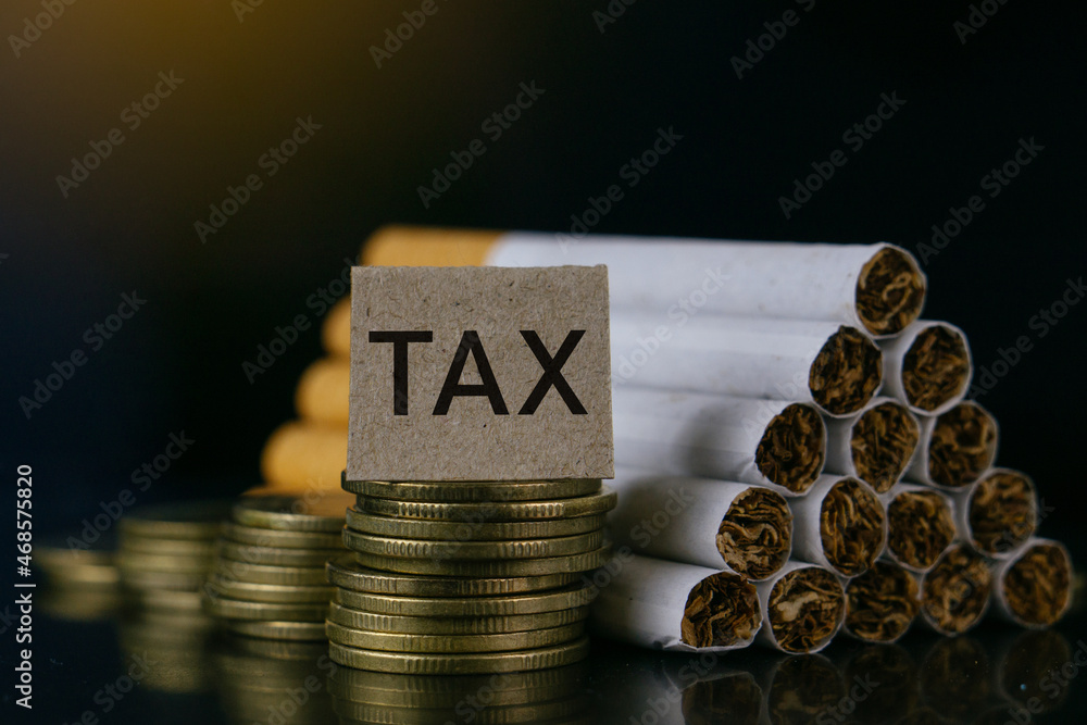Cigarettes.Tobacco Cigarettes and TAX word on black background ...