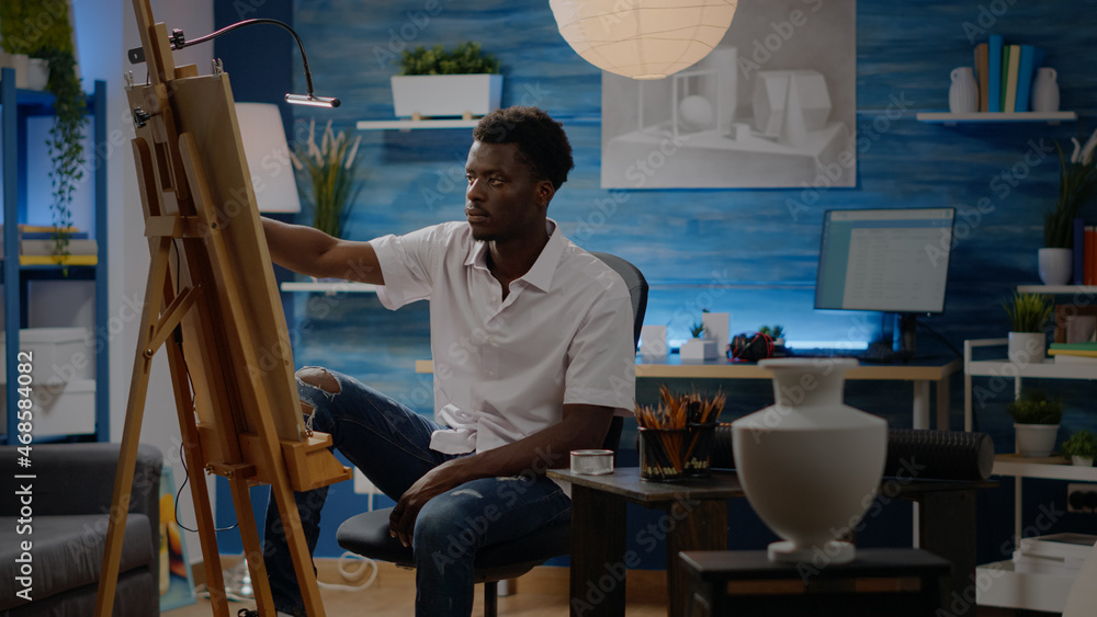 African american creative man using vase for drawing inspiration while ...