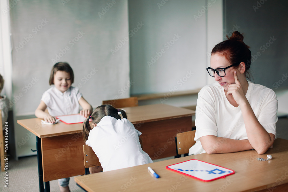 Crazy woman teacher at a desk with a girl student. Unusual photos of ...
