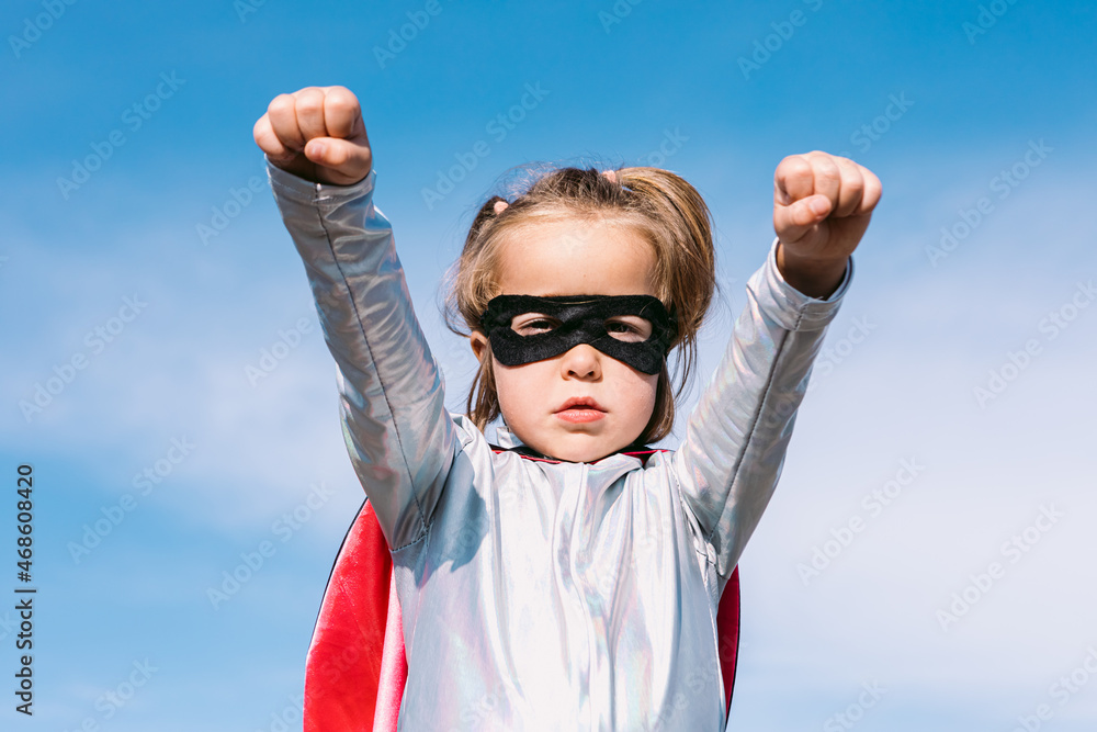 Brave kid in superhero costume showing fists Stock Photo | Adobe Stock