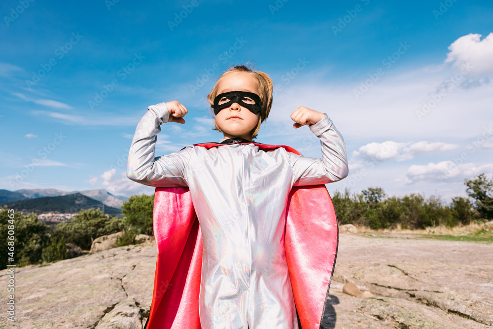 Brave superhero in costume showing muscles Stock Photo | Adobe Stock