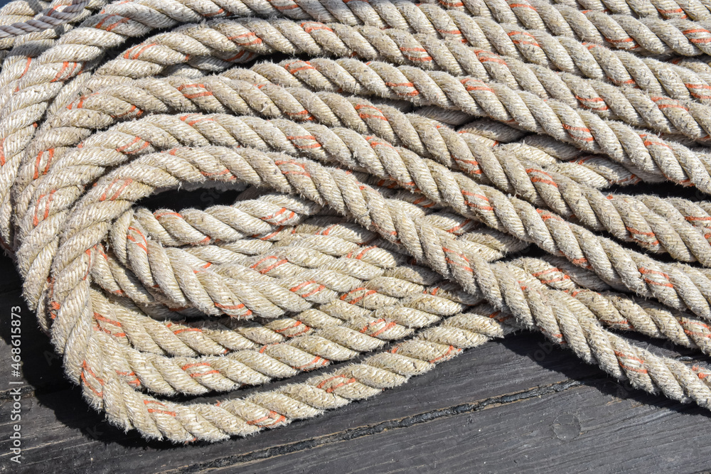Rope folded in a neat and orderly pattern on the deck of a sailing ...