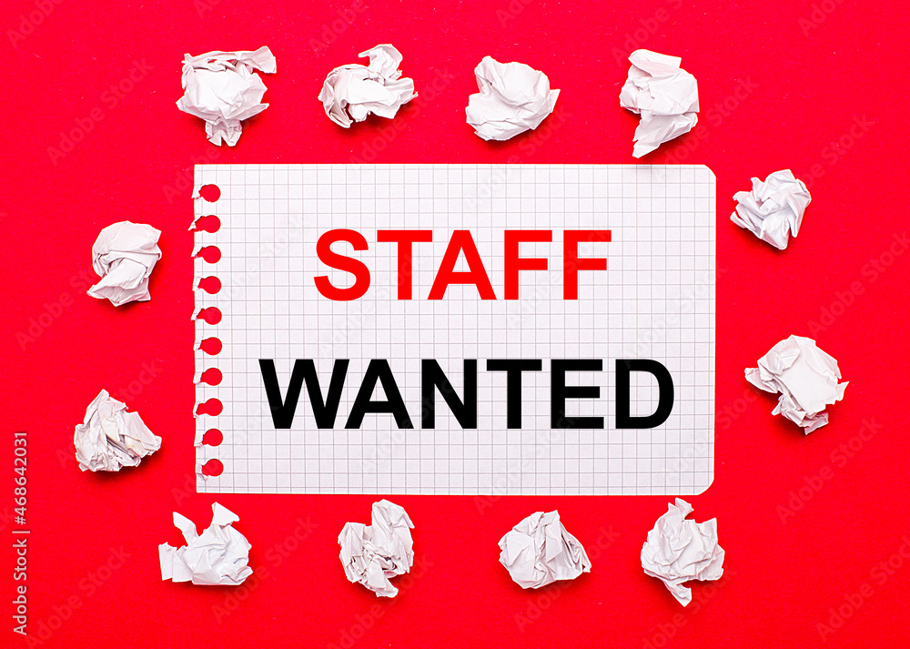 On a bright red background, white crumpled sheets of paper and a sheet ...