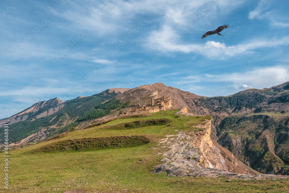Ruins and towers of the aul ghost Goor in Dagestan in the evening light ...