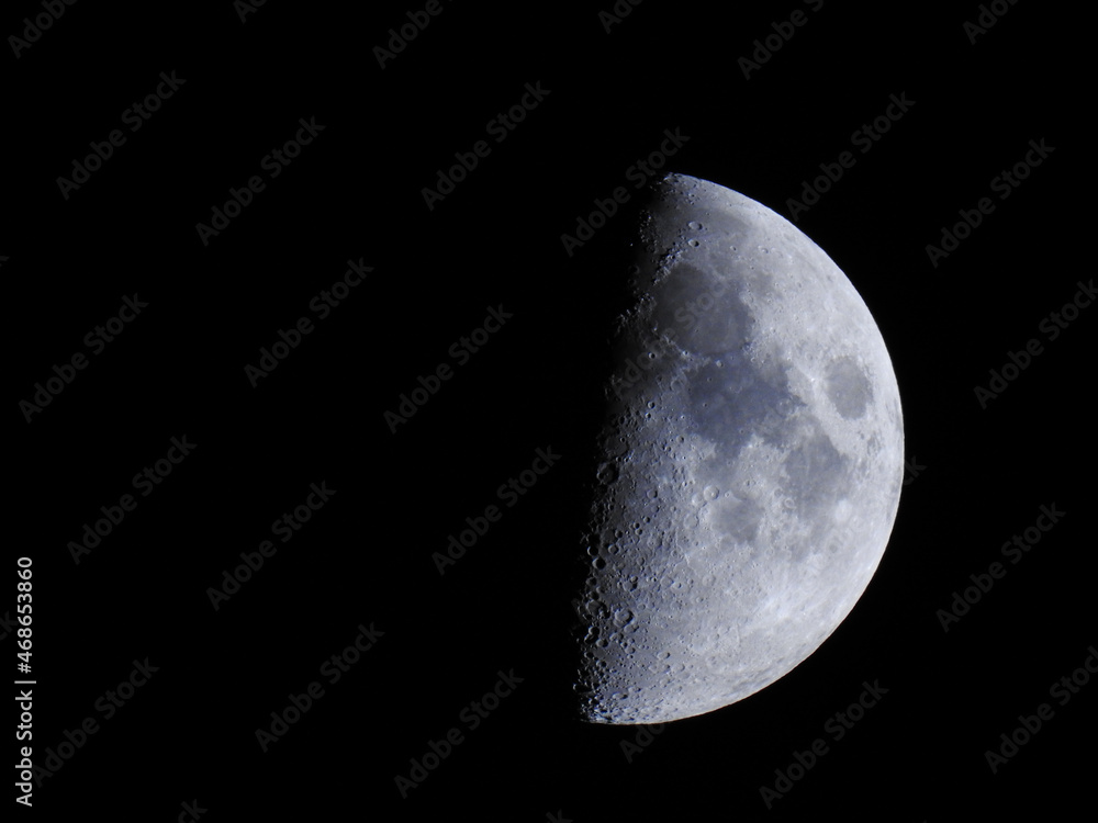 Half of the moon visible moon in the da night sky Stock Photo | Adobe Stock
