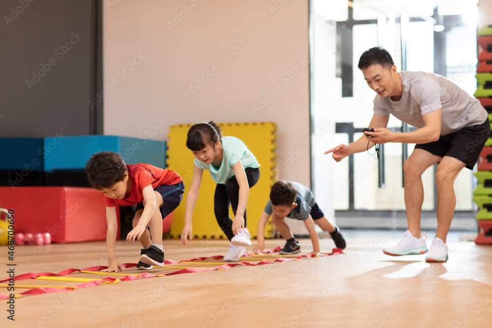 Cute children having exercise class in gym Stock Photo | Adobe Stock