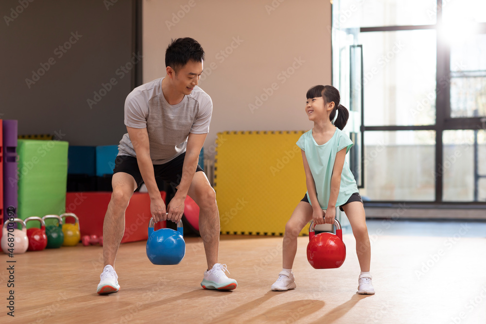 Little girl having exercise class in gym Stock Photo | Adobe Stock