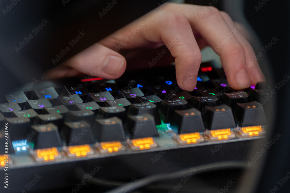 Focus on Hands, Keyboards and Mouse. Back view of young gamer playing ...