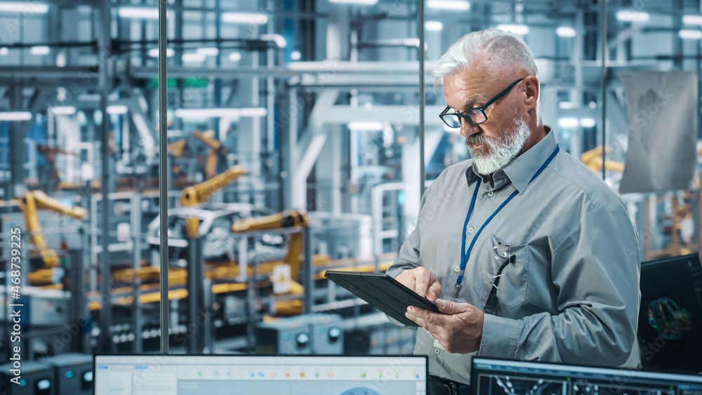 Car Factory Office: Portrait of Senior White Male Chief Engineer Using ...