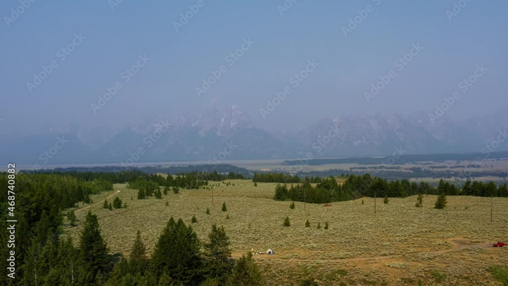 Aerial drone landscape nature tilting up shot of the Grand Tetons ...