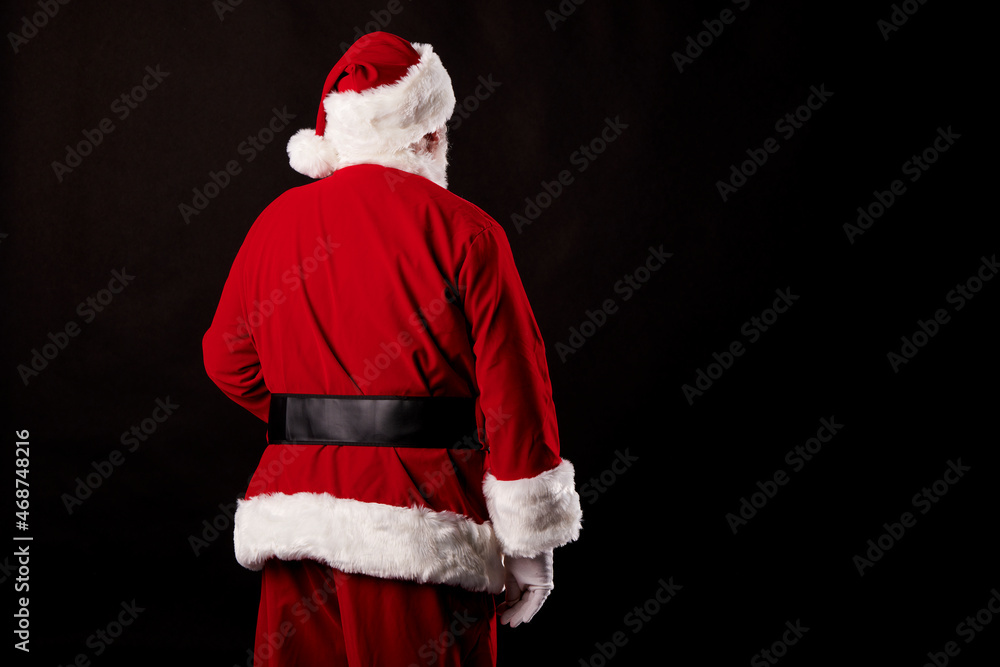 Santa Claus with his back unrecognizable on black background Stock ...
