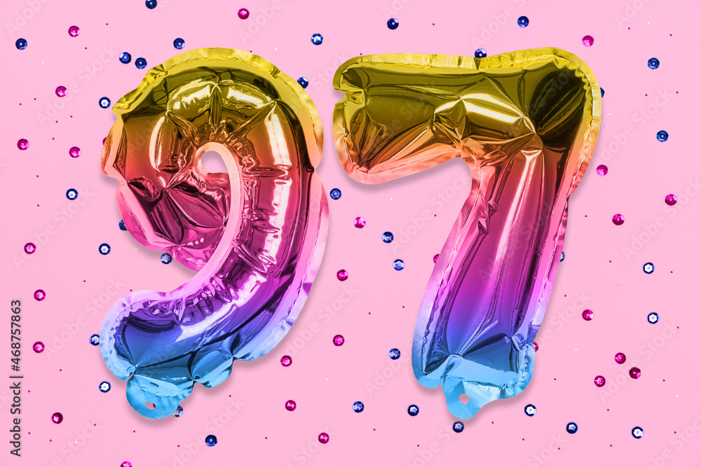 Rainbow foil balloon number, digit ninety seven on a pink background ...