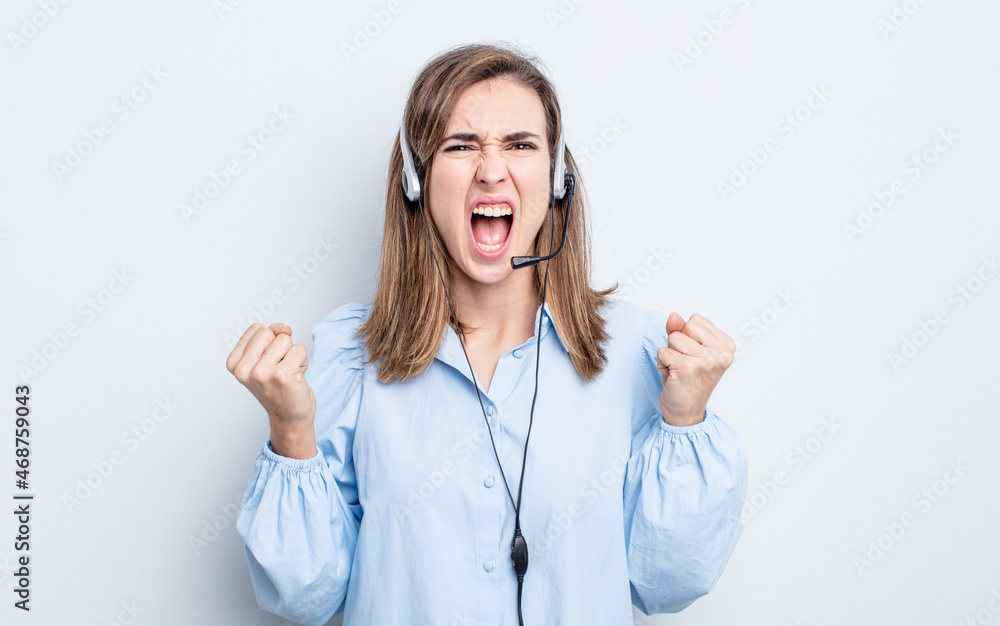 young pretty woman shouting aggressively with an angry expression ...