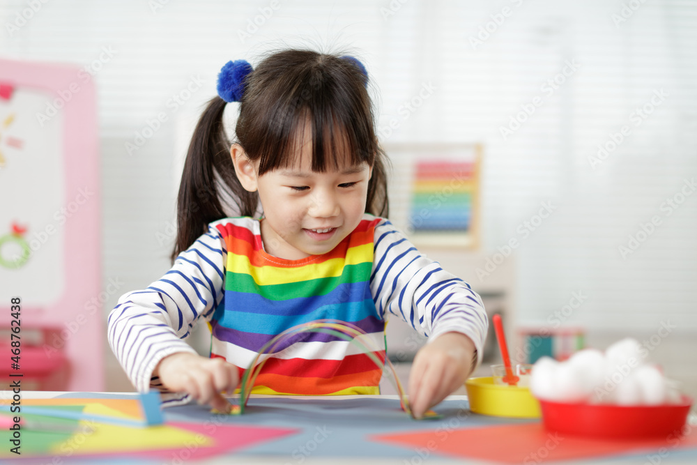 young girl making paper rainbow craft for homeschooling Stock Photo ...