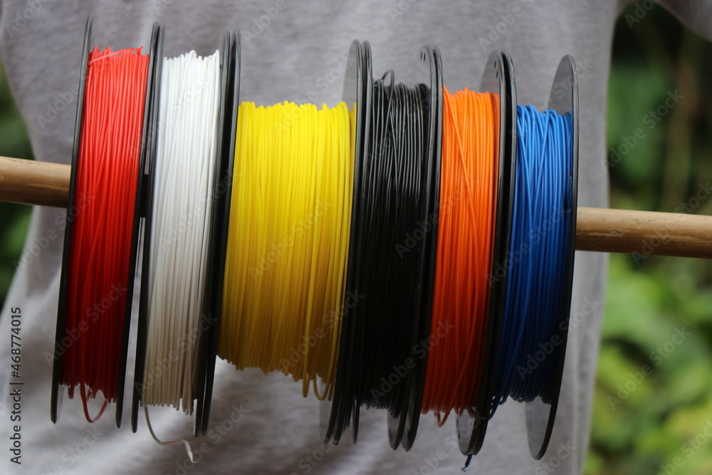 Spool of different colored Polylactic Acid or PLA filaments used for 3D ...
