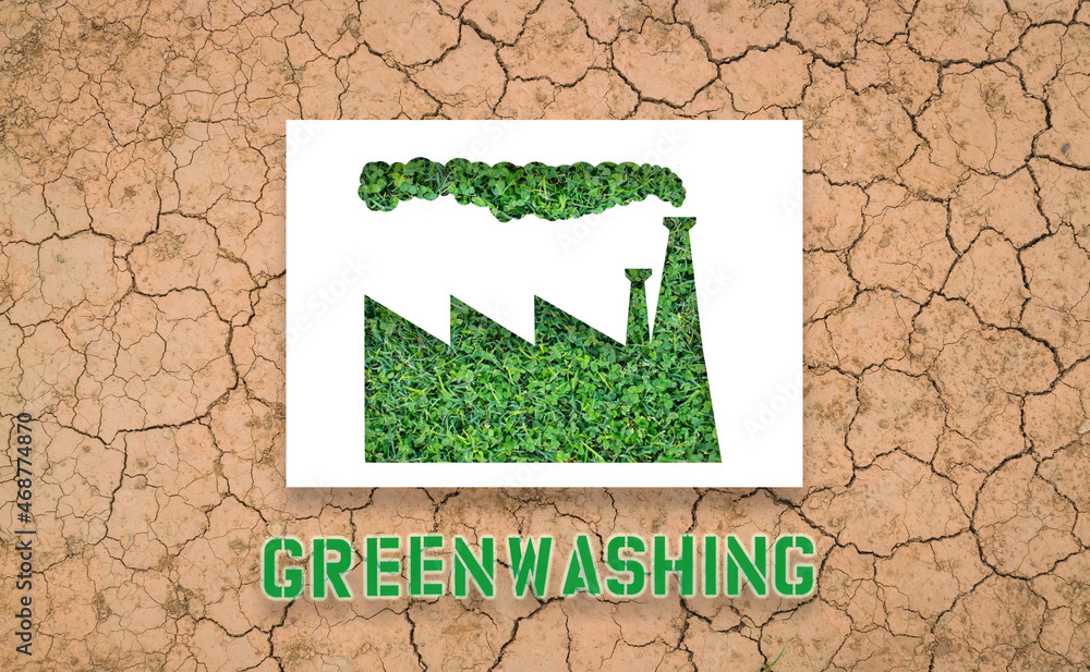 Green washing: sheet of paper with the outline of a factory cut out ...