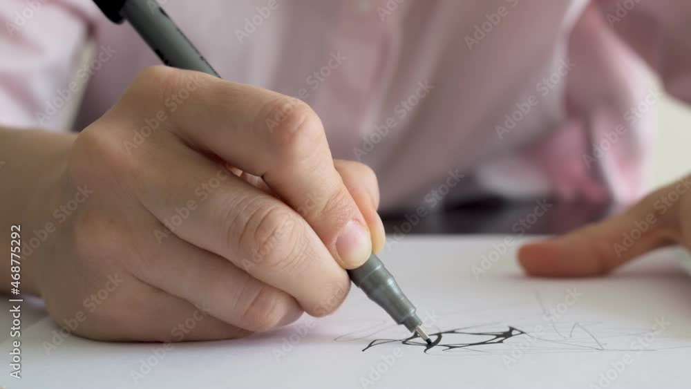 Drawing with a black marker on a sketch with a graphite pencil. Close ...