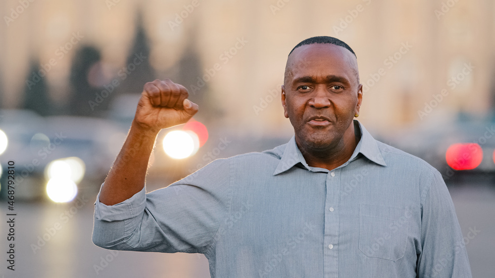 Confident Black African American retirement age man protests against ...