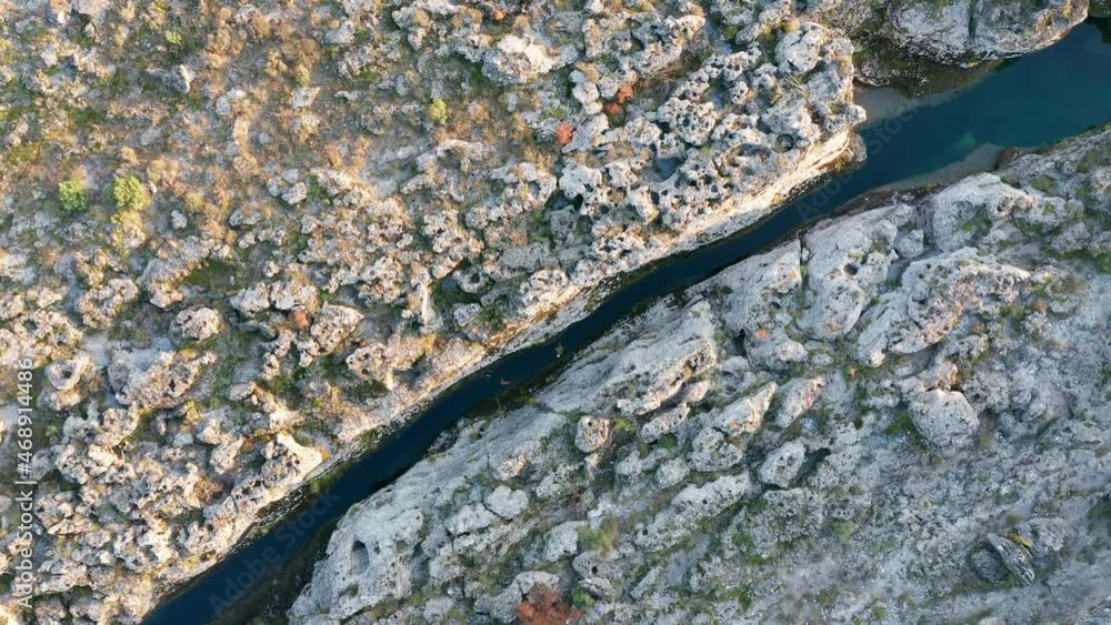 Narrow mountain river flowing through desolate rocky landscape. Stream ...