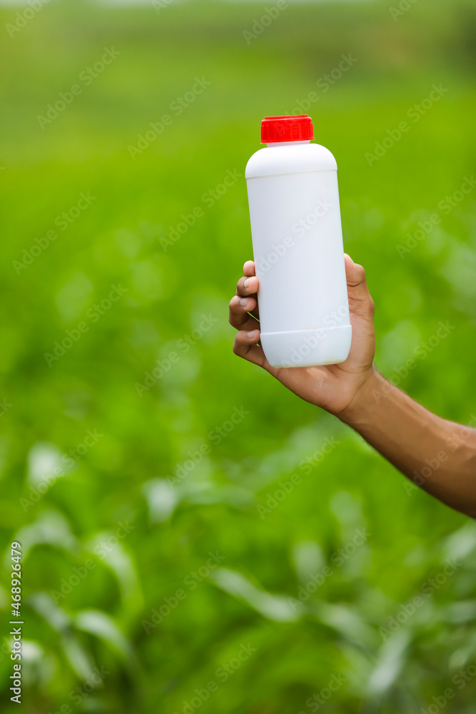 Protection of crops from pests and diseases. hand holding pesticide ...