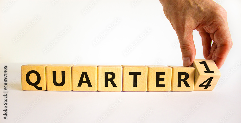 From 4th to 1st quarter symbol. Businessman turns a cube and changes ...