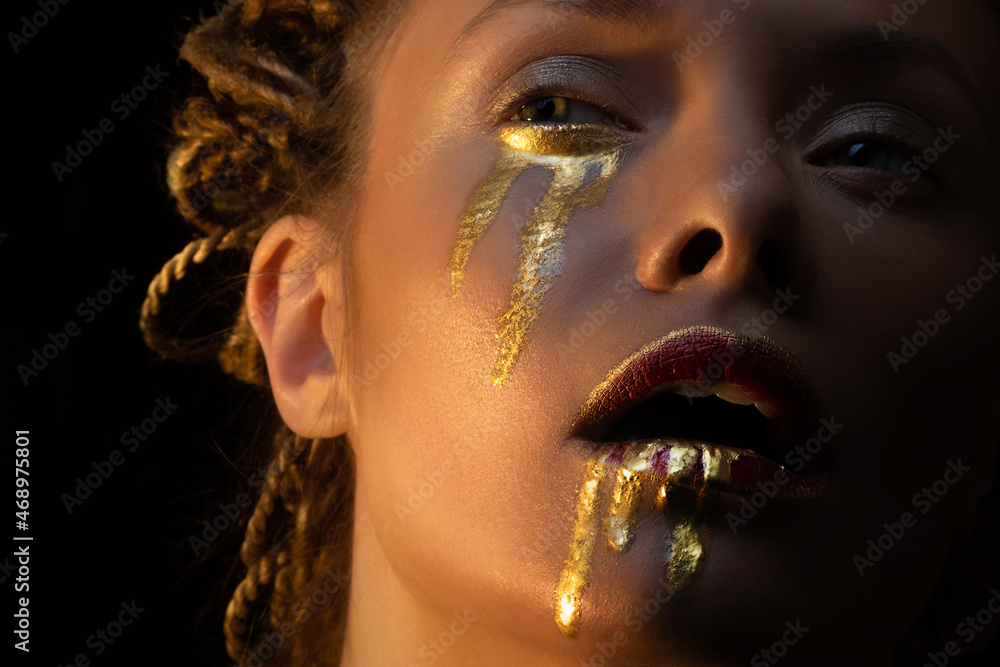 Gold on the skin, face art and creative makeup, gold as tears and blood ...