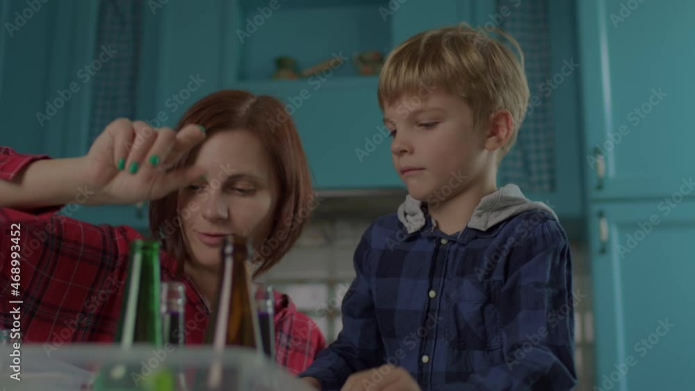 30s mother and son sorting recycle waste at home. Family happy to sort ...