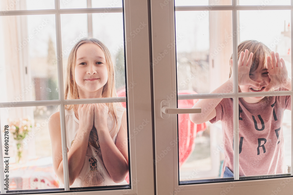 Portraits of little boy and girl, closed on the balcony, on the other ...