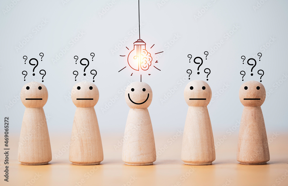 Smiley wooden human with light bulb and others human with question mark ...