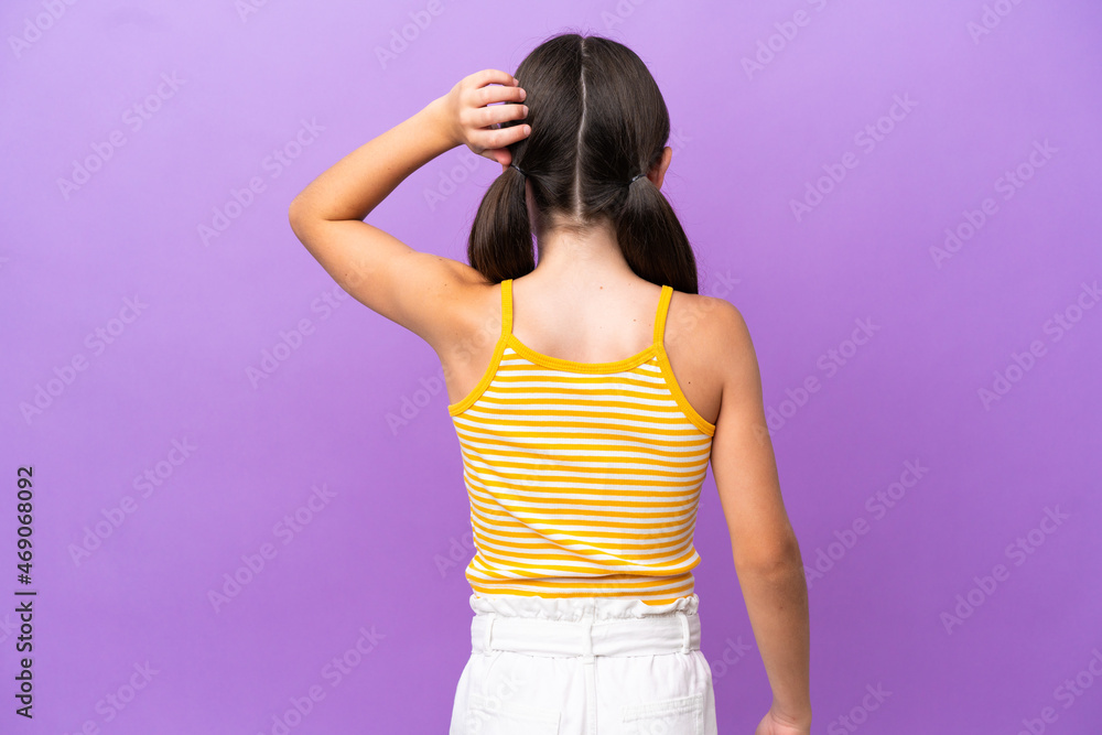 Little caucasian kid isolated on purple background in back position and ...