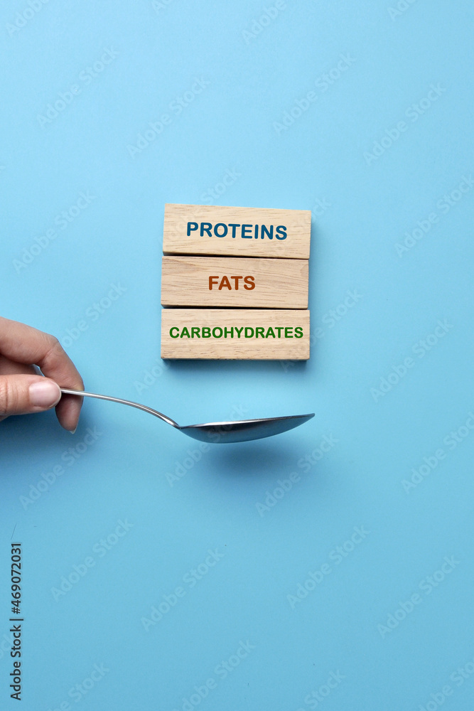 Wooden cubes with inscriptions: proteins, fats, carbohydrates. The ...