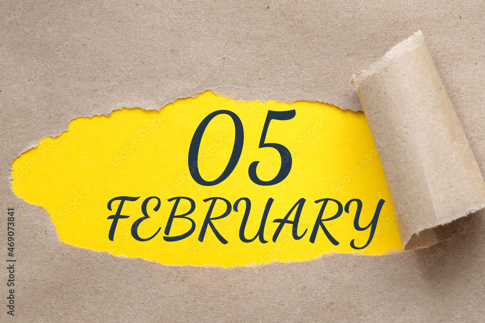 february 05. 05th day of the month, calendar date.Hole in paper with ...