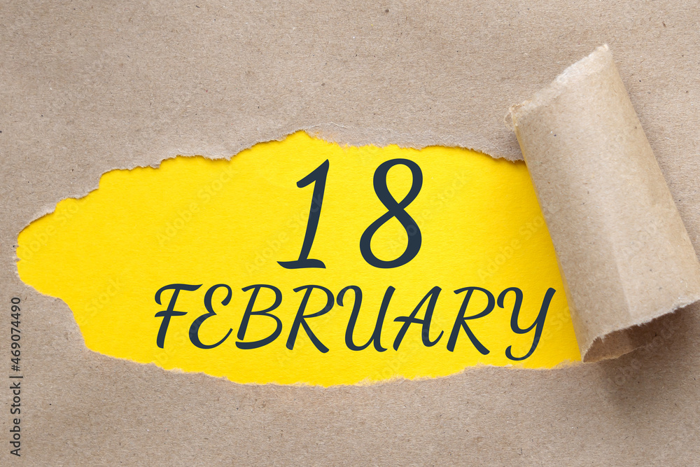 february 18. 18th day of the month, calendar date.Hole in paper with ...