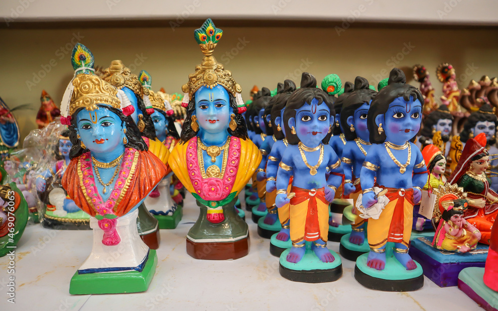A Collection of clay model dolls of Hindu God Krishna in vibrant colors ...