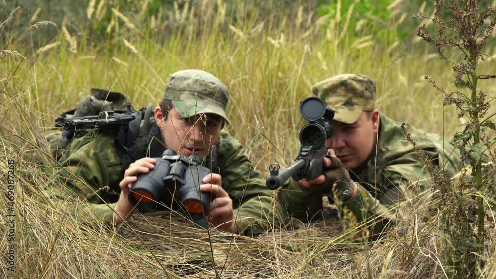 sniper with a gunner are sitting in ambush in the bushes Stock Video ...