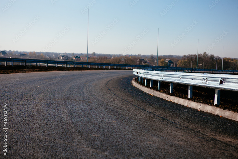 red road reflectors along the road. metal road fencing of barrier type ...