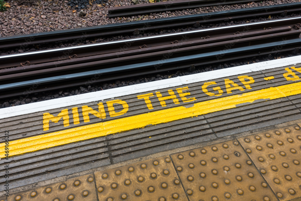 London, England, November 13th 2021:A mind the gap yellow painted floor ...