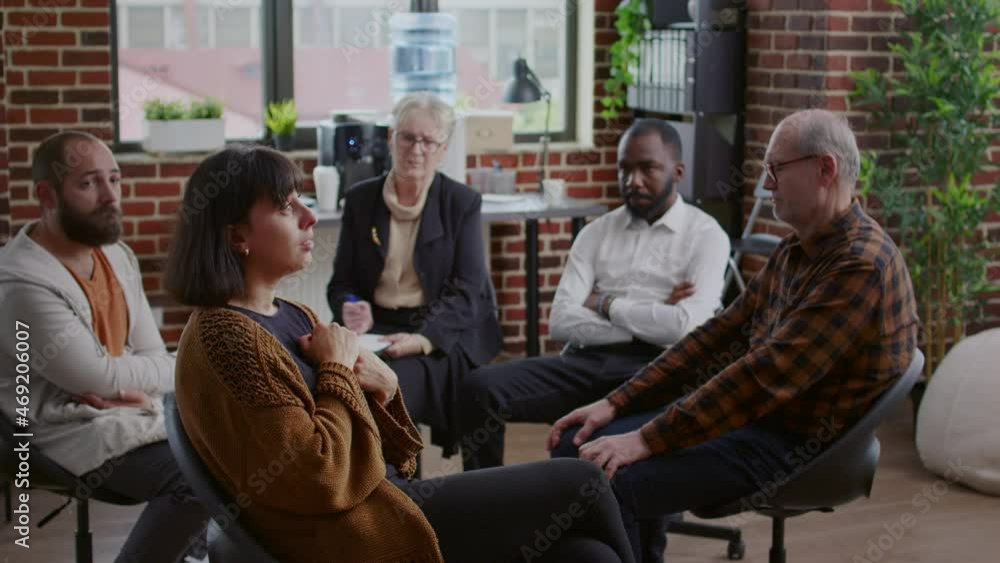 Woman making confession and crying in front of people at aa rehab ...