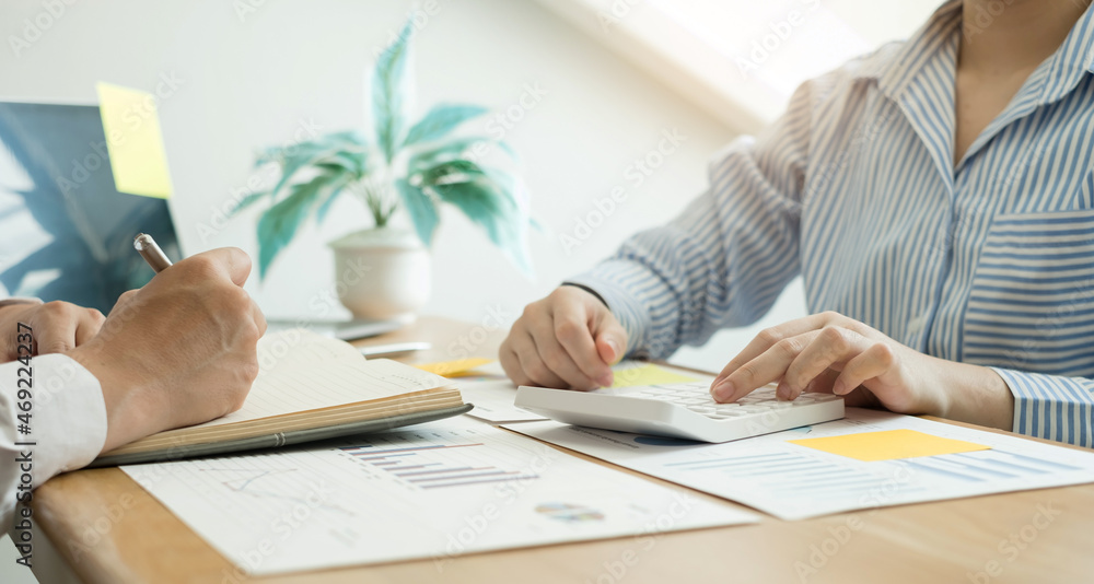 Two business leaders talk about charts, financial graphs showing ...