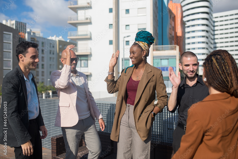 Happy business people giving high fives to each other. Smart-dressed ...