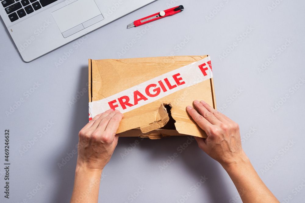 Broken fragile parcel, torn cardboard box, stolen items Stock Photo ...