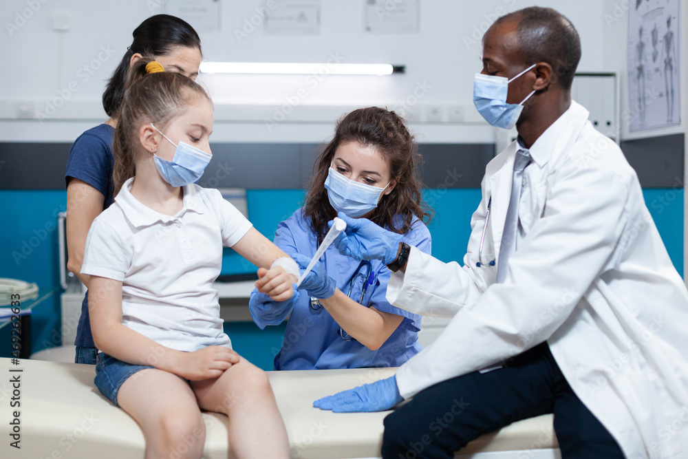 African american doctor bandage kid patient broken arm after having ...